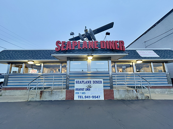 The iconic Seaplane Diner sign welcomes hungry travelers with its distinctive aircraft perched above&mdash;a beacon of breakfast hope on Allens Avenue.