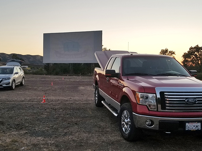 The golden California sunset creates the perfect backdrop for movie magic at Lakeport Auto Movies, where trucks and SUVs gather for showtime.