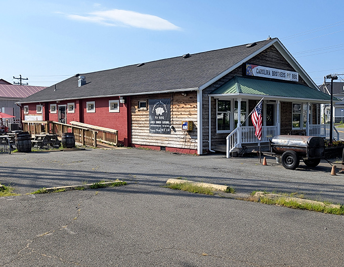 The rustic wooden exterior of Carolina Brothers beckons like a barbecue siren song. That green metal roof has sheltered countless smoked meat dreams.