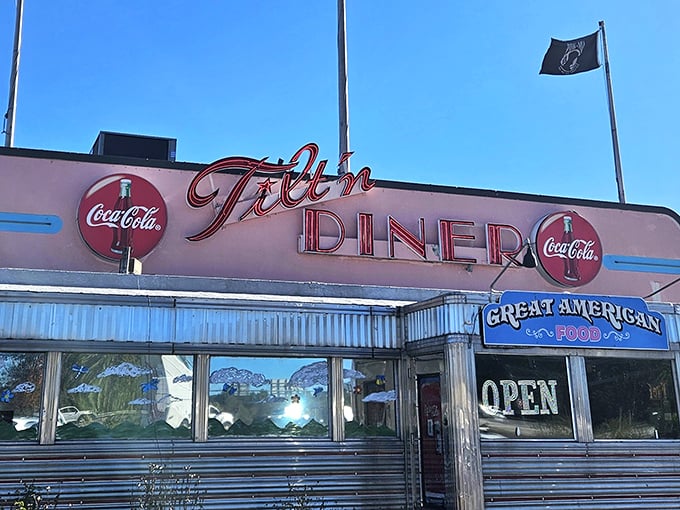 The iconic Tilt'n Diner sign glows against the New Hampshire sky like a beacon for hungry travelers. Classic Americana at its finest.