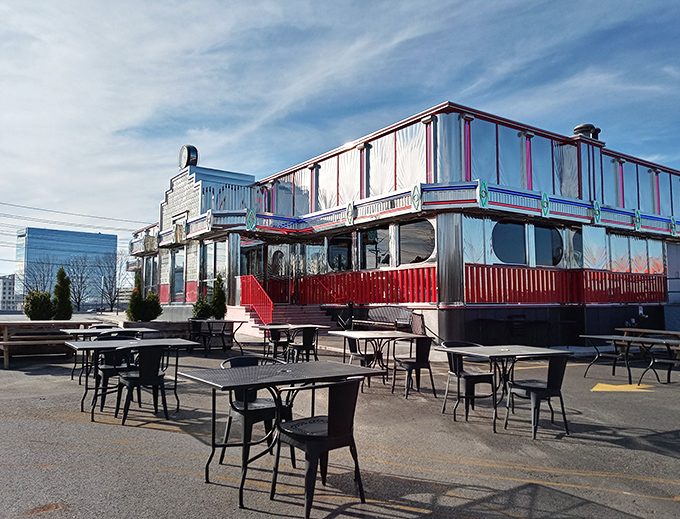Bathed in daylight, the chrome-clad diner reveals its retro charm, with outdoor seating perfect for people-watching while debating the merits of disco fries versus loaded waffle fries.