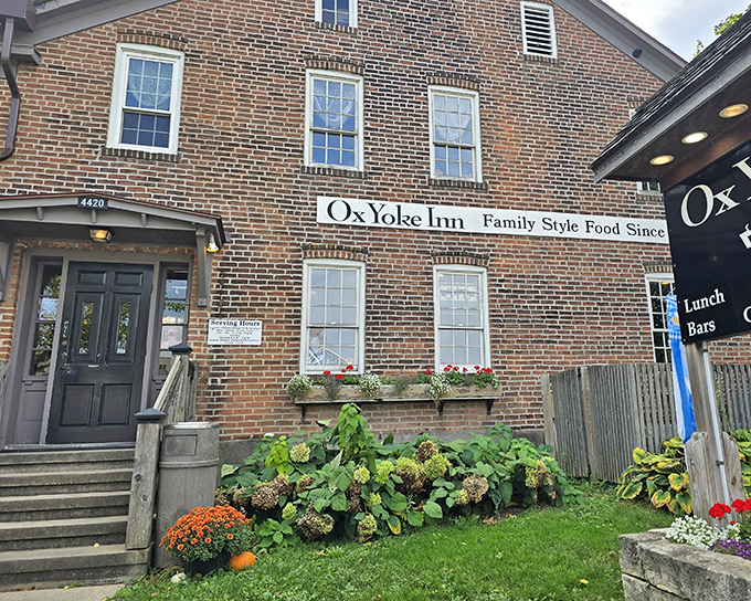 The iconic brick exterior of Ox Yoke Inn welcomes hungry travelers with colorful flower beds and a promise of German-American comfort that's stood the test of time.