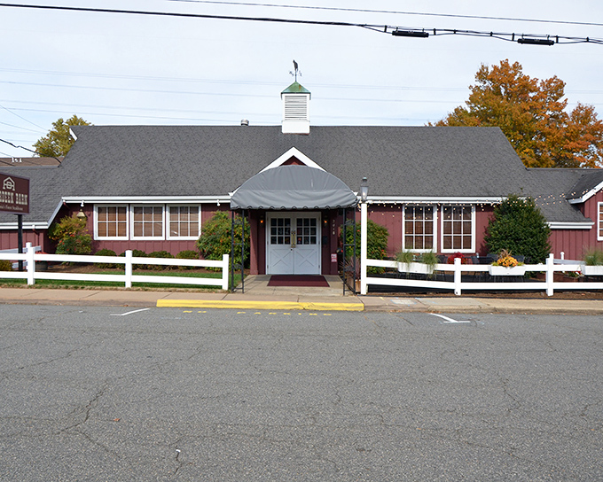 That rustic barn exterior with its classic white fence isn't just charming &ndash; it's your destination for beef nirvana.