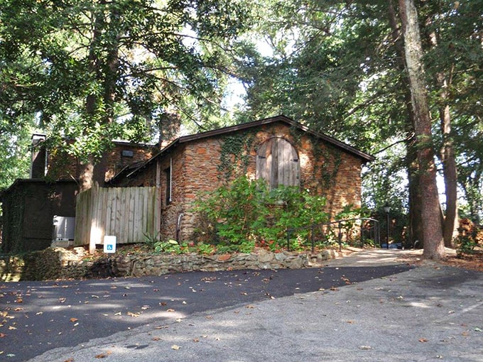 This charming, vine-covered stone building, nestled among the trees, promises a truly legendary Southern dining experience within.