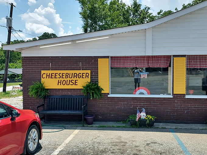 Those iconic red-checkered curtains and bright yellow "CHEESEBURGER HOUSE" sign aren't just decoration—they're a promise of authentic American comfort food that's stood the test of time.