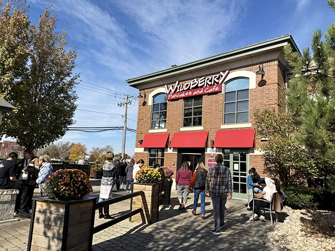 The brick facade of Wildberry with its signature red awnings beckons like a breakfast lighthouse guiding hungry souls to pancake paradise.