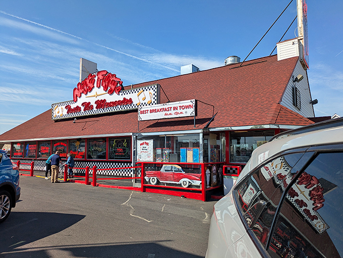 The classic red-roofed Nifty Fifty's stands like a time machine disguised as a diner, beckoning hungry travelers with promises of nostalgia and calories worth consuming.