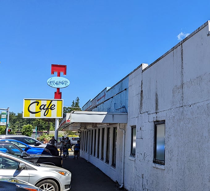 The vintage neon sign beckons hungry travelers like a beacon of hope in a world of fast food monotony.