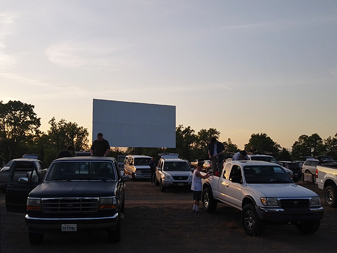 The golden California sunset creates the perfect backdrop for movie magic at Lakeport Auto Movies, where trucks and SUVs gather for showtime.