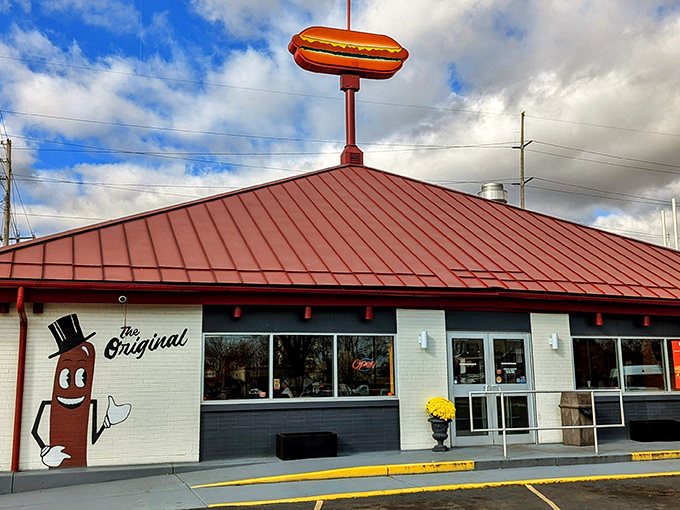 The iconic hot dog sign stands proudly atop the red roof, like a beacon of deliciousness calling to hungry travelers across Warren.
