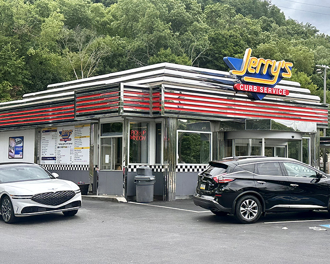 The gleaming stainless steel and red stripes of Jerry's Curb Service stand as a beacon of hope for hungry travelers&mdash;a mid-century modern masterpiece serving timeless American classics.