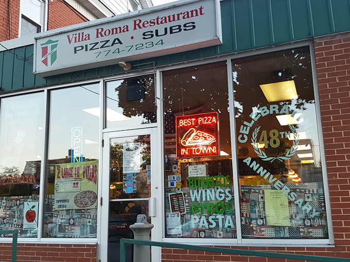 The unassuming storefront with its classic neon "BEST PIZZA IN TOWN" sign isn't just making empty promises&mdash;it's a time portal to pizza perfection.