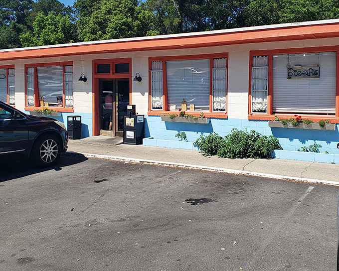 The unassuming exterior with its cheerful orange trim promises what every great roadside find delivers&mdash;authentic food without the fuss or pretension.