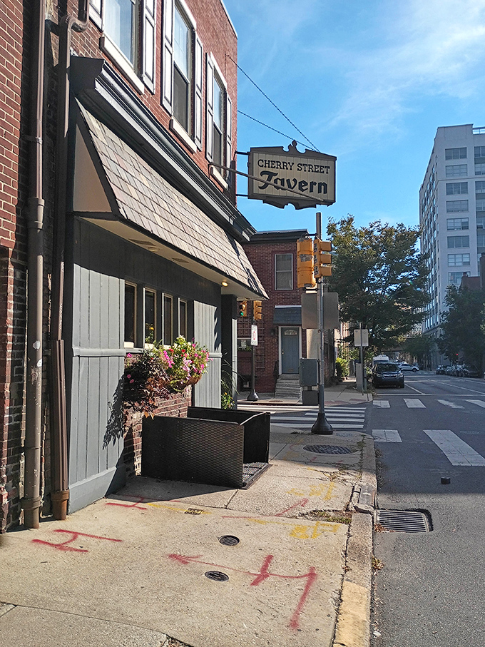 The unassuming brick exterior of Cherry Street Tavern stands like a time capsule amid Philadelphia's urban landscape, its vintage sign promising authentic experiences inside.
