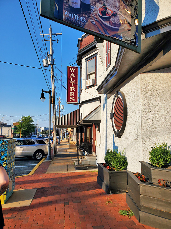 The iconic red WALTERS sign beckons hungry carnivores like a lighthouse guiding ships to safe harbor on Wilmington's brick-paved streets.
