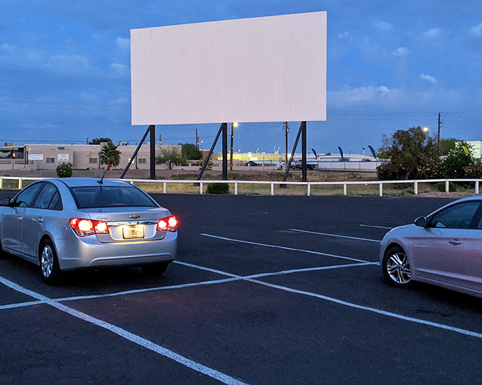The massive screen awaits as dusk settles over Glendale. There's something magical about watching movies under an Arizona sky that Netflix just can't replicate.