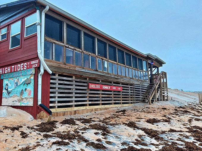 Where ocean meets appetite &ndash; this weathered wooden structure stands defiantly on the sand, waves practically high-fiving the stilts during peak tide.