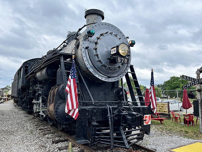 Locomotive #578 stands proudly at the Ohio Railway Museum, its gleaming headlight and American flags telling stories of journeys past. Iron horse poetry in metal and steam.