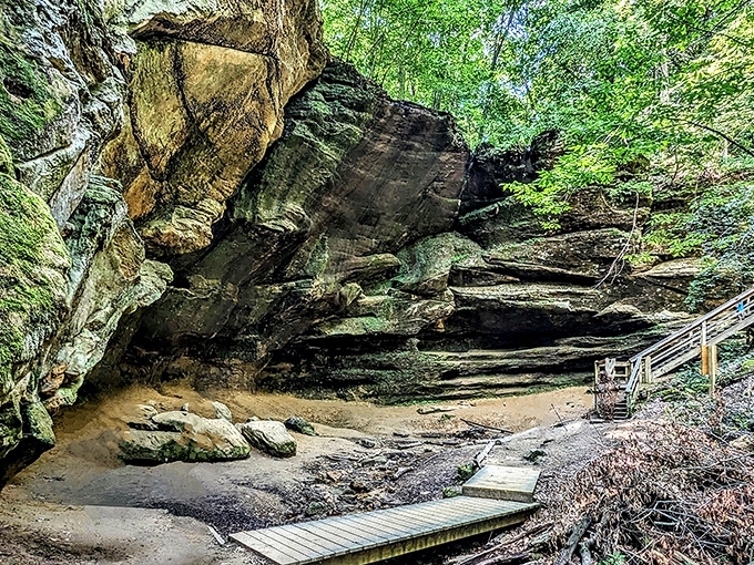 Ancient sandstone cliffs embrace a wooden boardwalk at Mohican State Park, inviting hikers to explore nature's magnificent geological masterpiece.