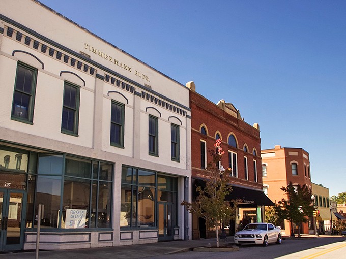 Historic storefronts line a peaceful street in downtown Opelika, Alabama, showcasing the town&rsquo;s charming small-town character and timeless architecture.