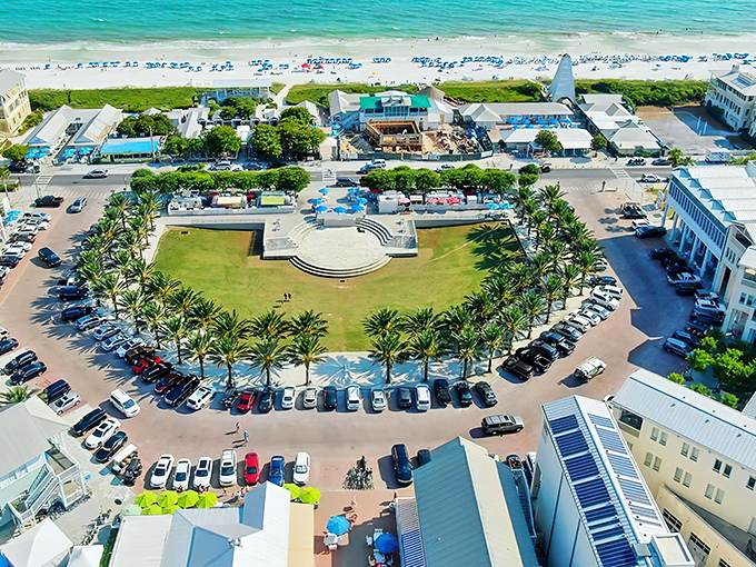 Seaside's central amphitheater viewed from above—where palm trees stand guard around a perfect circle of community life, proving paradise can indeed be planned.