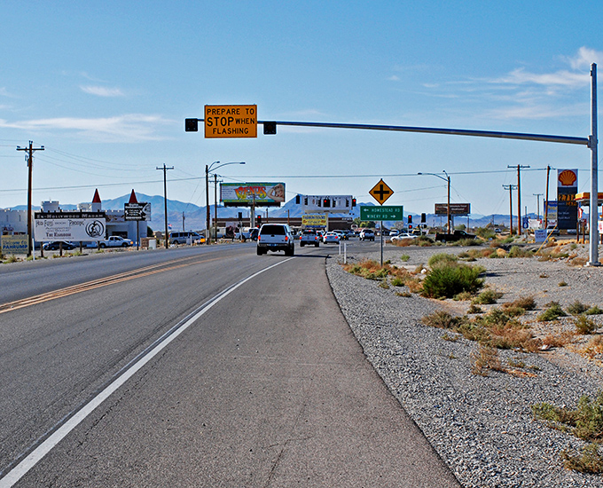 Highway 160 stretches toward the horizon, promising adventure with every mile. The mountains stand guard over Pahrump's desert charm.