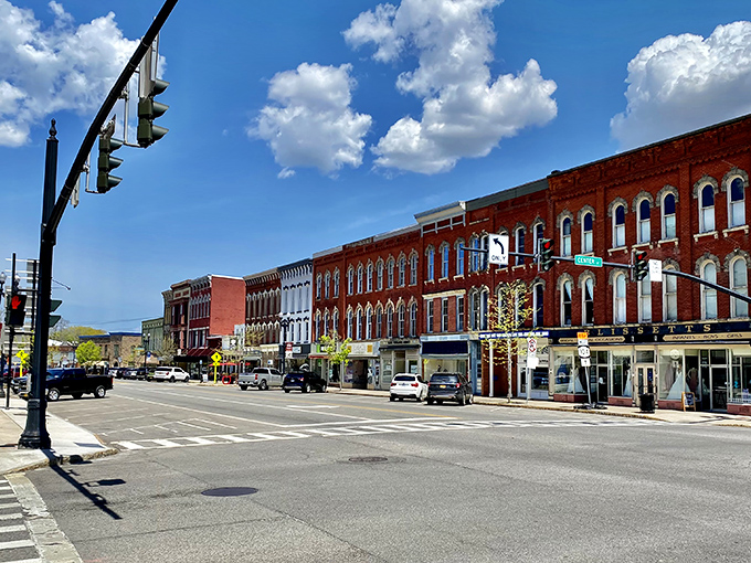 Historic Main Street Medina shines under blue skies, those red sandstone buildings standing proud like architectural superheroes who've been saving the day since the 1800s.
