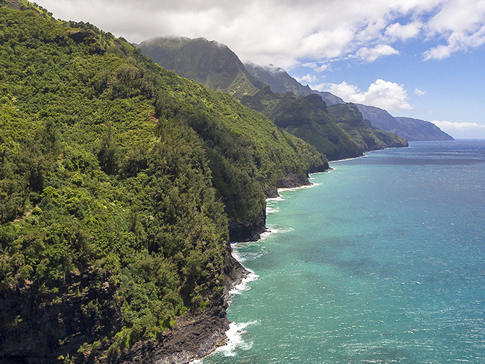 Nature's skyscraper: The lush mountain backdrop at Hā'ena State Park makes Manhattan's skyline look like amateur hour. Paradise, unfiltered.