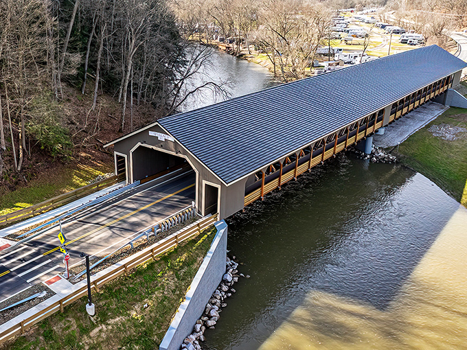 The Mohican Bridge stretches across the river like a wooden time machine, inviting travelers to slow down and savor the journey.