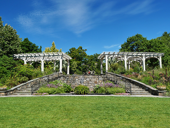 Grand stone staircases flanked by elegant white pergolas create a scene straight out of a Jane Austen novel, minus the corsets and awkward proposals.