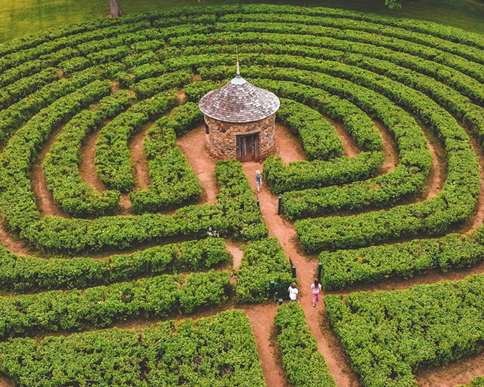 The ultimate garden maze showstopper&mdash;where privet hedges and philosophical journeys meet at a stone grotto centerpiece.