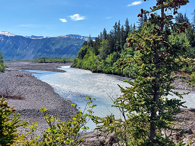 Mother Nature's own watercolor masterpiece &ndash; glacial waters carve through pristine wilderness while mountains stand guard like ancient sentinels.