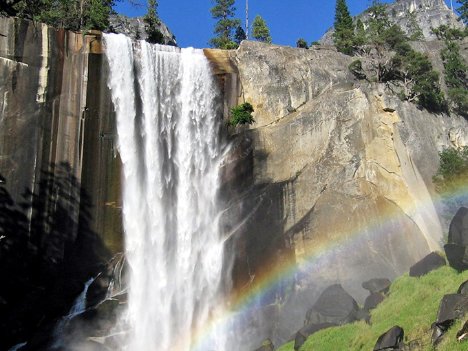 Nature's own light show: Vernal Falls creates a perfect rainbow against ancient granite, proving Mother Nature was the original Instagram influencer.