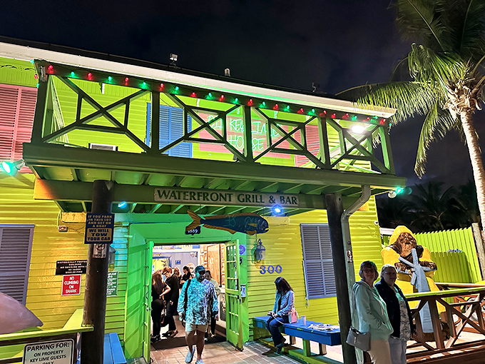 As night falls, the neon-bright entrance welcomes seafood pilgrims with twinkling lights and the promise of Florida's finest waterfront dining experience.