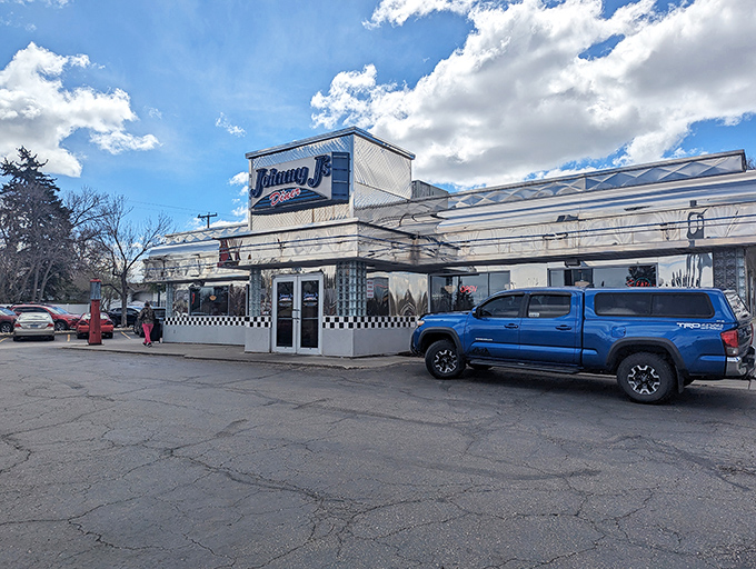 The gleaming silver exterior of Johnny J's Diner beckons like a time machine disguised as a restaurant. Classic checkerboard trim seals the deal.