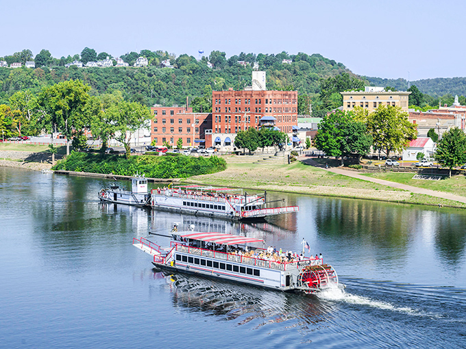 Riverboats glide along the Ohio River like time travelers from a bygone era, with Marietta's historic brick buildings standing sentinel on the shore.