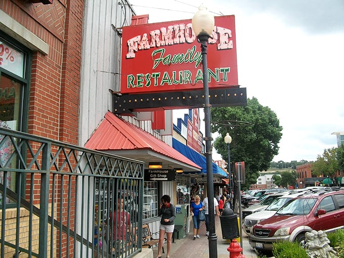 The iconic red and white Farmhouse Family Restaurant sign stands out against the Branson sky, promising comfort food that transcends time and trends.
