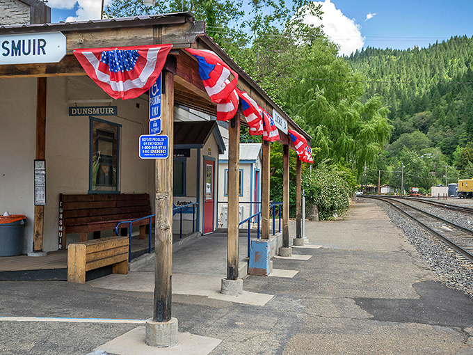 Dunsmuir's historic train station welcomes visitors with patriotic bunting and mountain views, a charming first impression of this railroad town frozen in time.