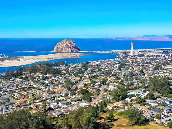 From this bird's-eye view, Morro Bay unfolds like a model train village, with the famous volcanic plug commanding attention against the azure Pacific.
