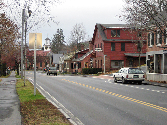 Classic New England charm on full display: Woodstock's historic homes with their pristine white fences stand like sentinels of simpler times.