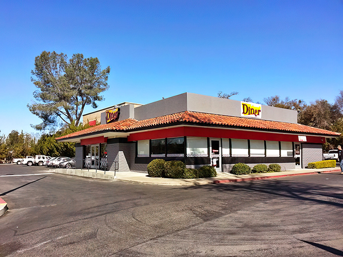 The classic red-roofed A-Town Diner stands like a beacon of breakfast hope against the California blue sky, promising comfort food salvation to hungry travelers.