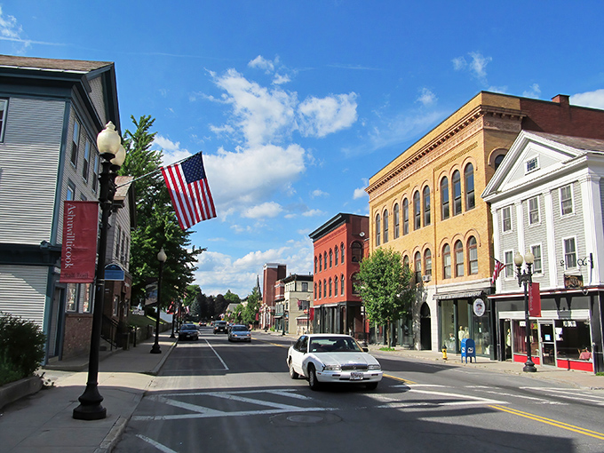 Park Street's historic charm feels like stepping into a Norman Rockwell painting come to life, complete with classic American flags and timeless brick facades.