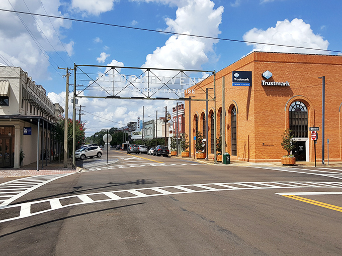 Downtown Brookhaven welcomes visitors with its iconic overhead sign, where historic brick buildings frame streets that feel like a warm Southern embrace.
