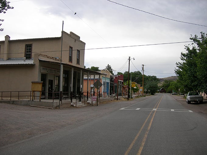 Main Street Hillsboro stands frozen in time, where the American flag waves proudly over adobe buildings that have witnessed over a century of southwestern stories.