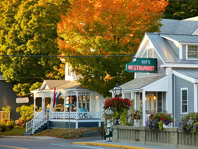 Dot's Restaurant stands like a sentinel of comfort food beneath Vermont's autumn canopy. The iconic neon sign has welcomed hungry travelers for generations.