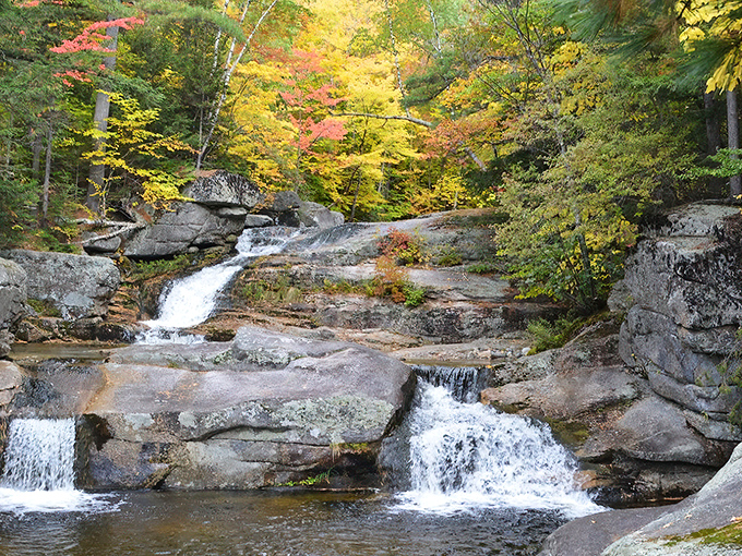 Nature's own watercolor masterpiece: Screw Auger Falls framed by autumn foliage that makes even professional photographers question their camera settings.