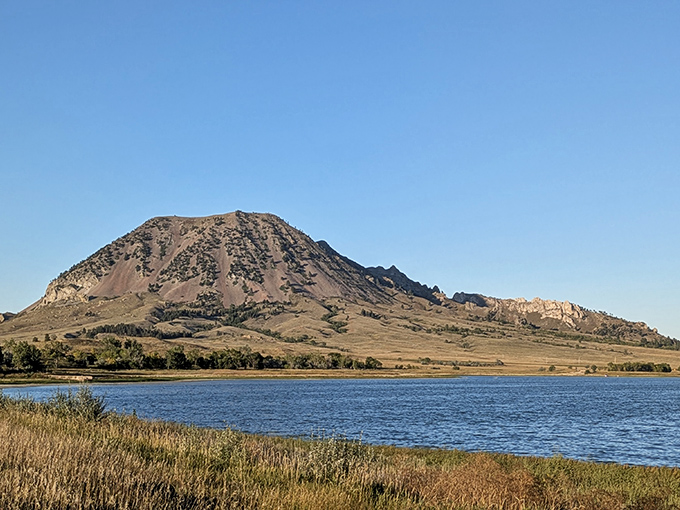 Mother Nature's masterpiece stands proud against the South Dakota sky, with Bear Butte reflecting in the lake like it's admiring its own magnificence.