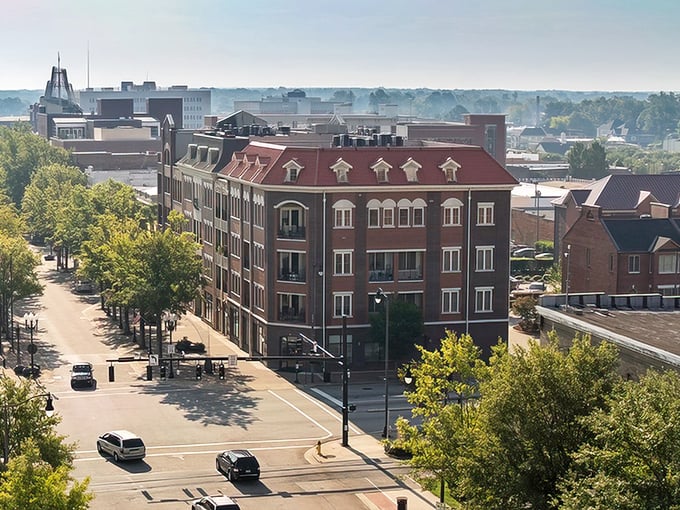 Aerial views reveal Fayetteville's thoughtful urban planning, with tree-lined streets and brick buildings creating neighborhoods where retirement dollars stretch like summer evenings.
