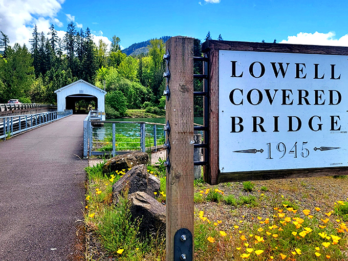 The Lowell Covered Bridge stands like a pristine white sentinel against Oregon's emerald waters, inviting travelers to step back in time.
