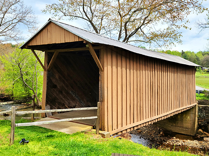 The classic wooden silhouette of Jack's Creek Covered Bridge stands like a time portal in the Virginia countryside, inviting travelers to step back into a simpler era. 